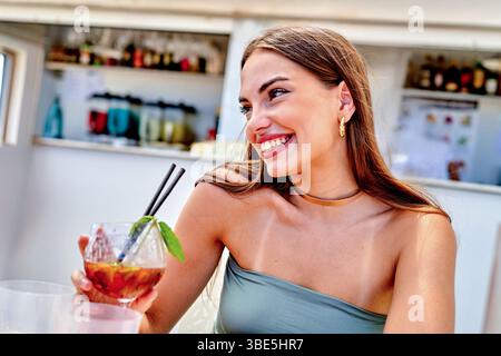 Woman smiles, holding drink in traditional Korean attire. Bright colors ...