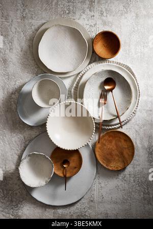 Different plates with bowls and spoon on blue background Stock Photo ...