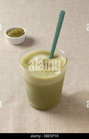 Green powder sits in bowl on colorful surface Stock Photo - Alamy