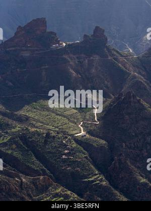 Aerial view of roque bentayga with winding road and village in a rugged ...