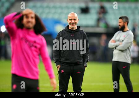 Chelsea manager Enzo Maresca (centre) looks on as the players warm up ...