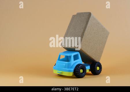 Truck transporting a cardboard box, package delivery Stock Photo - Alamy