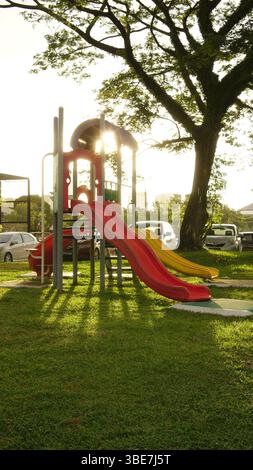 Slides and swings for children at a community playground with mountain ...