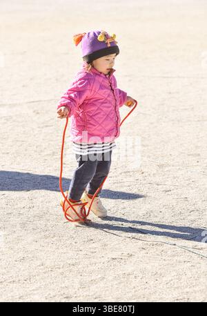 Toddler child outdoors. One year old baby boy wearing straw hat holding ...