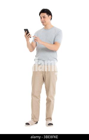 A young man staring at his phone screen, absolutely thrilled with his ...