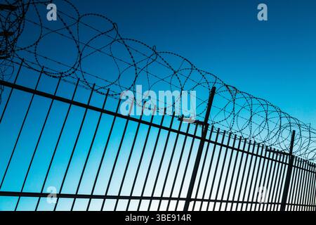 Barbed wire fence enclosing a closed area Stock Photo - Alamy