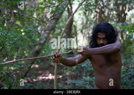 Vedda tribesman of Sri Lanka Hunting in the jungle with a bow and arrow ...