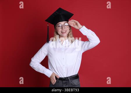 Happy student after graduation on orange background Stock Photo - Alamy