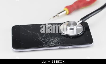 Diagnosing the phone with a stethoscope, near a screwdriver. Phone ...