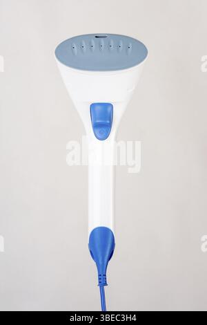 Steam iron in hand, isolated on white Stock Photo - Alamy