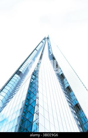 Low angle view of sleek glass building exterior with dark metal grid ...