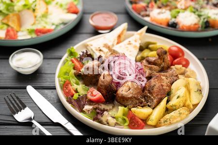 Flatbread with herbs on a plate with sauces. appetizing snack. Close-up ...