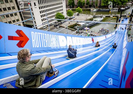 ROTTERDAM - Visitors use the Rotterdam Rooftop Roller Coaster during ...