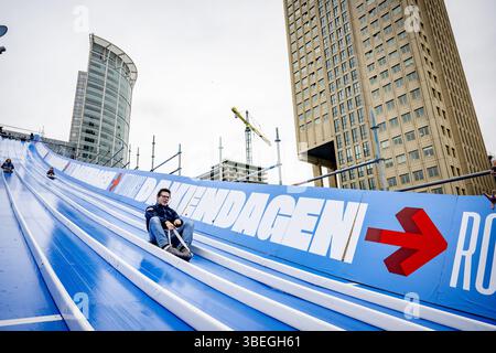 ROTTERDAM - Visitors use the Rotterdam Rooftop Roller Coaster during ...
