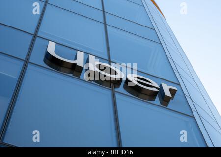 Uber logo on glass facade of modern office building, San Francisco ...
