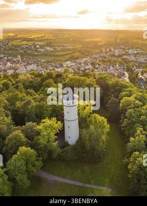 A townscape on a hill surrounded by dense vegetation Stock Photo - Alamy