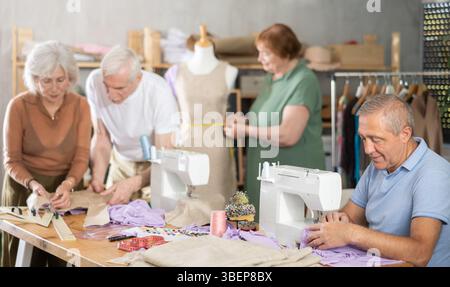 Group of elderly people at sewing master class Stock Photo - Alamy