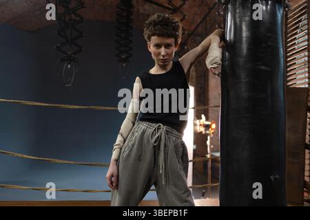 Short-haired fighter in boxing ring, cinematic rest moment between ...