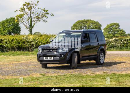 Modified black Land Rover Discovery Series I 4x4 climbing a dusty hill ...