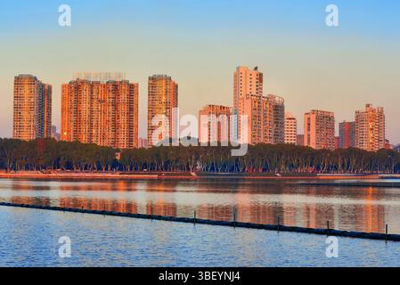 Cityscape of Jiujiang City at sunset over the Sai Lake, Jiangxi ...