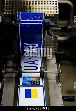 A license plate for Ukraine's delegation is being printed ahead of the ...