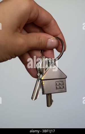 House shaped keychain with house purchase agreement Stock Photo - Alamy