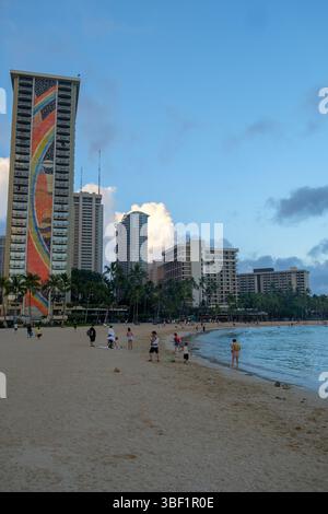 Tourists enjoy Waikiki Beach, Oahu, Hawaii. People are swimming ...