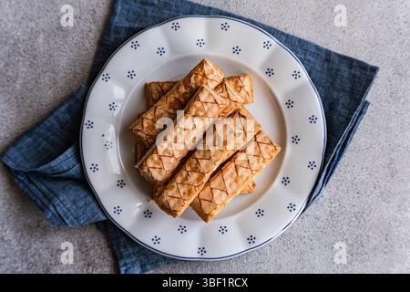 Homemade puff pastry sticks with apricot jam served on concrete table ...