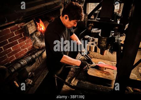 Craftsman forges handmade knife at Takefu Knife Village Stock Photo - Alamy