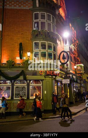 A pub window in Dublin city center advertising take away coffe and ...