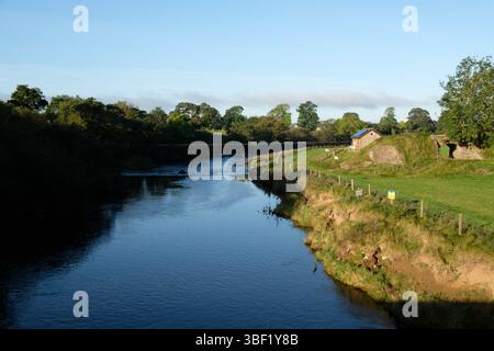 The River Eden flows past ruins and a building with solar panels ...