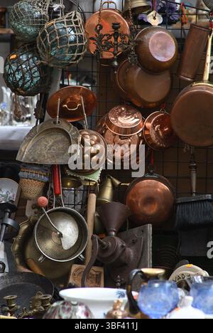 Colorful flea market stall filled with vintage objects, antiques, and ...