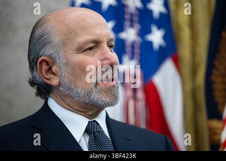Secretary of Commerce Howard Lutnick looks on as President Donald Trump ...
