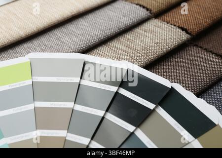 Samples of different fabrics and color selection chart as background ...