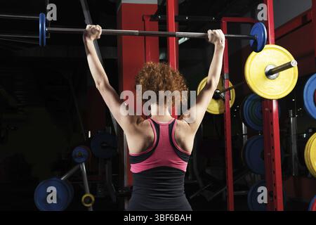 Woman bodybuilder engaged with a barbell in the gym Stock Photo - Alamy