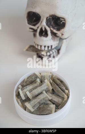 Skull Chewing Tobacco on a White Table Stock Photo - Alamy