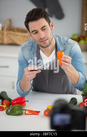 Professional chef chopping chili peppers for preparing food Stock Photo ...
