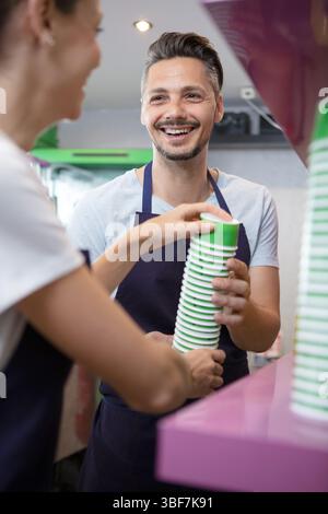 ice cream parlour worker restocking cones Stock Photo - Alamy