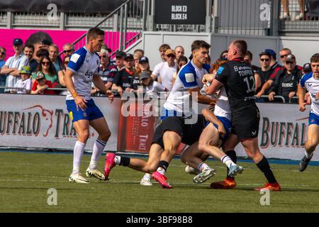 Saracens' Charlie Bracken (right) is tackled by Sale Sharks' Ernst Van ...