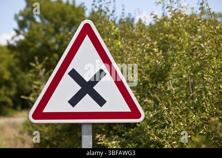 Triangular crossroads road sign on a country road junction Stock Photo ...