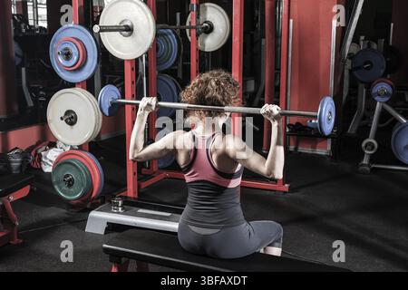 Woman bodybuilder engaged with a barbell in the gym Stock Photo - Alamy