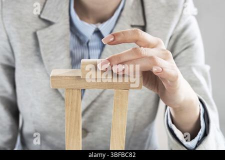 Business woman building tower from wooden blocks Stock Photo - Alamy