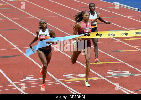 Melissa Jefferson-Wooden (C) crosses the finish line to win the women's ...
