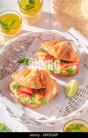Hot and golden french croissant with fish and avocado. Croissants as ...