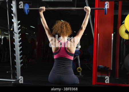 Woman bodybuilder engaged with a barbell in the gym Stock Photo - Alamy