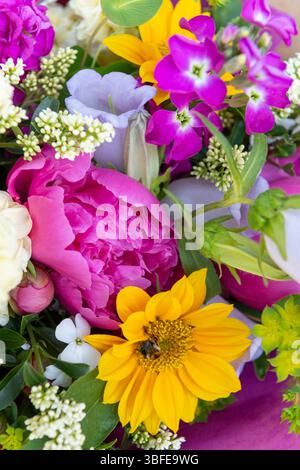 Wrapped flower bouquet made of mixed spring flowers. Beautiful pastel ...