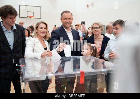 A voter casts her ballot with her children in a referendum on whether ...