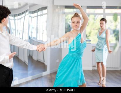 Passionate teen dancers, girl and boy practicing ballroom dancing in ...