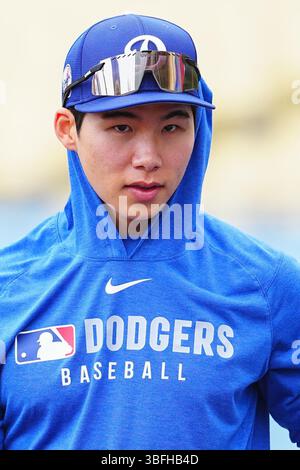 Los Angeles Dodgers' Hyeseong Kim follows through on a double during ...