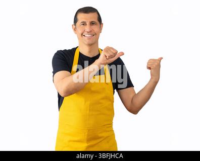 Hispanic man standing over yellow background covering eyes with arm ...